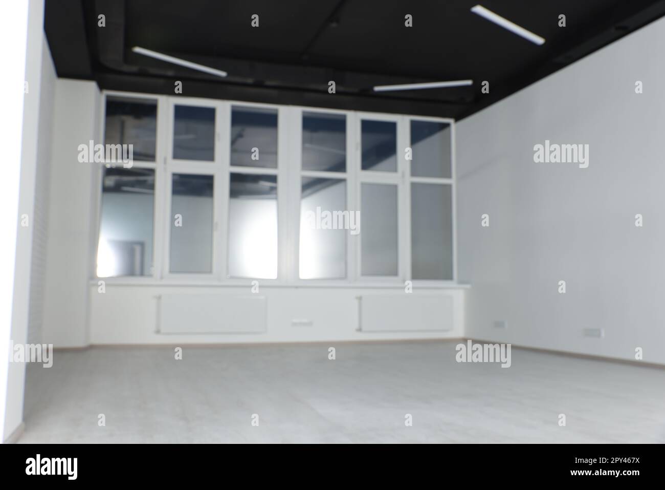 Empty office room with black ceiling and clean windows. Interior design ...
