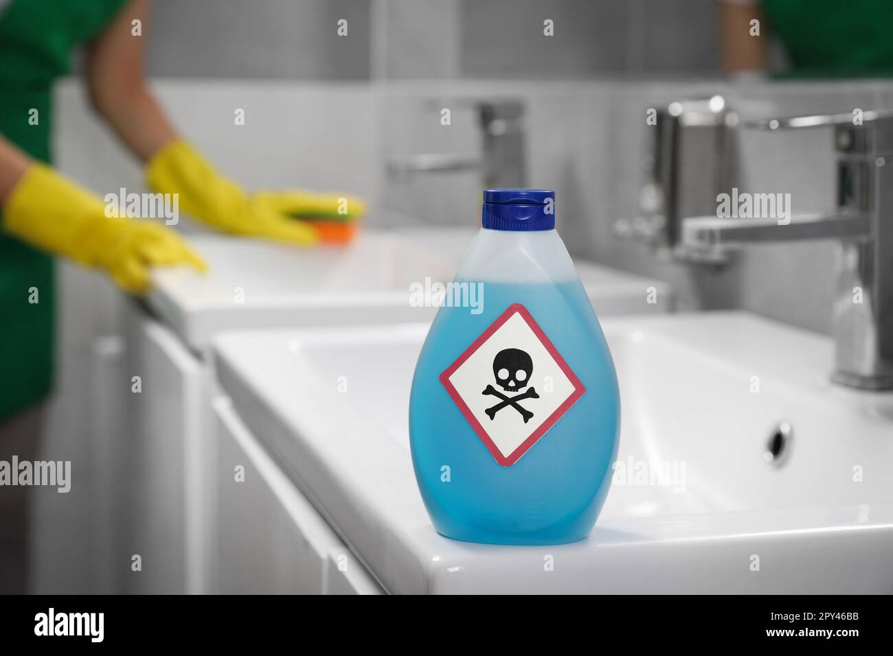 Bottle of toxic household chemical with warning sign in bathroom Stock ...