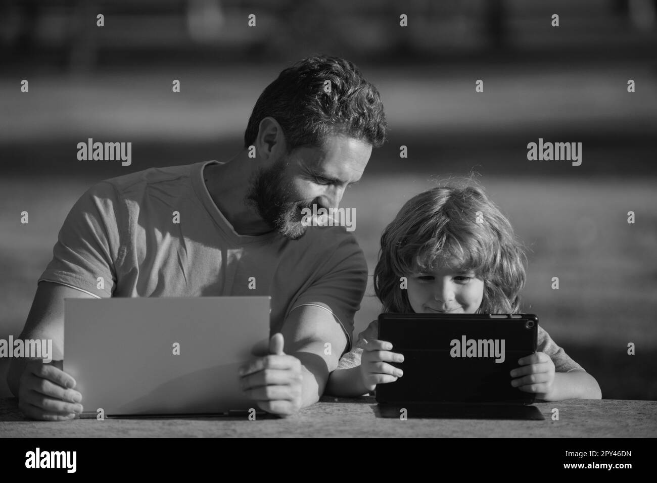 Father and son with laptop and tablet. Online learning. Kid with a ...
