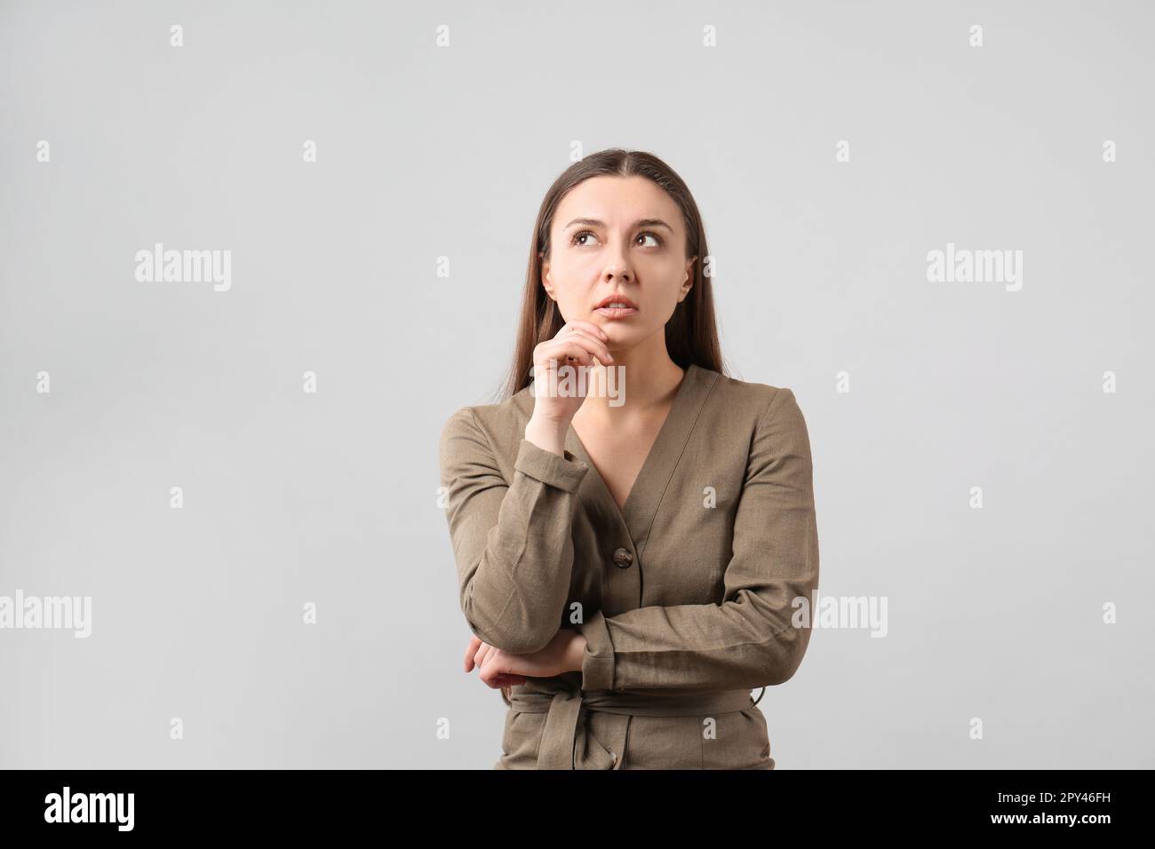Portrait of young woman on light grey background. Personality concept ...