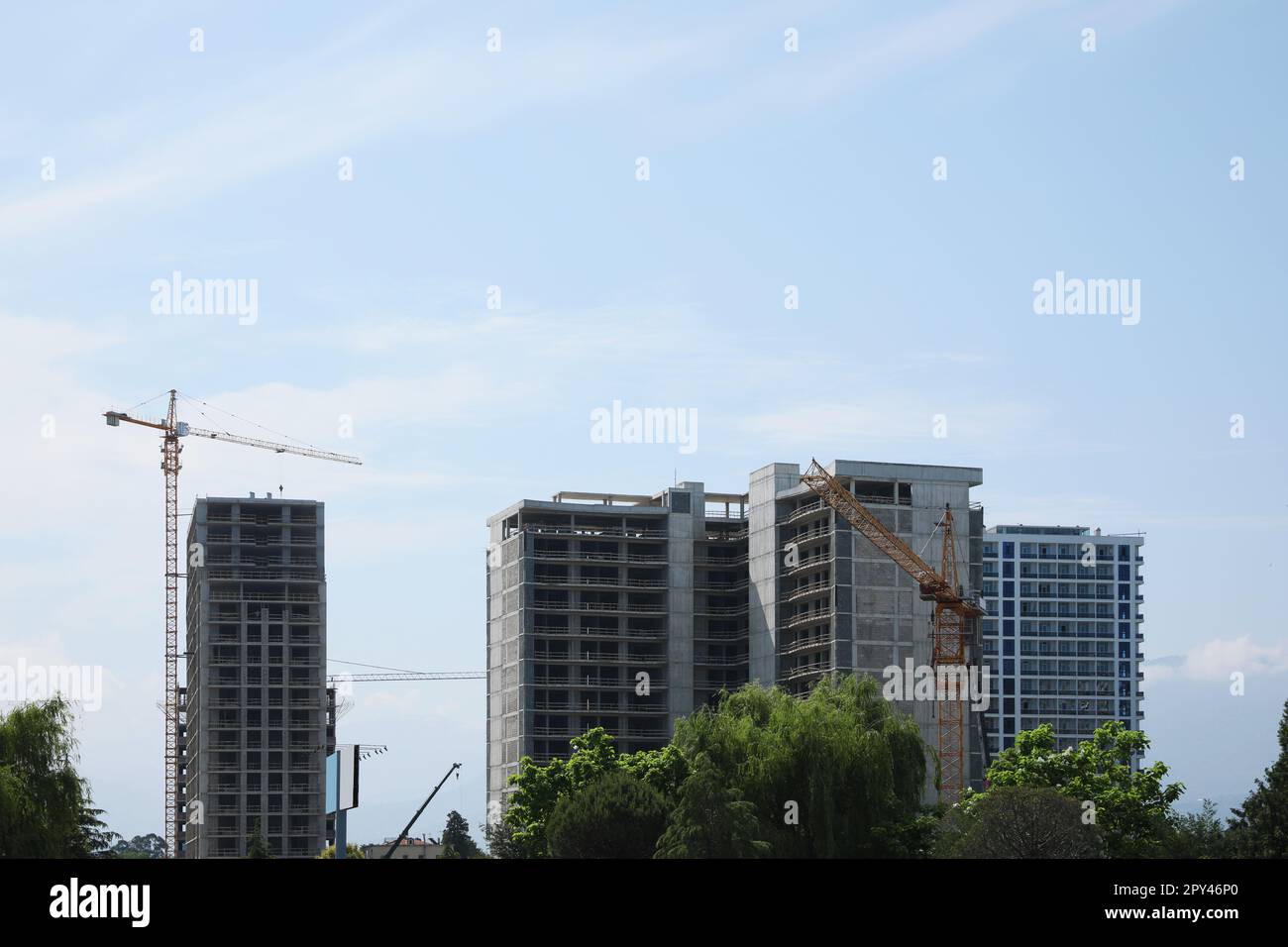 Construction site with tower cranes near unfinished buildings Stock ...