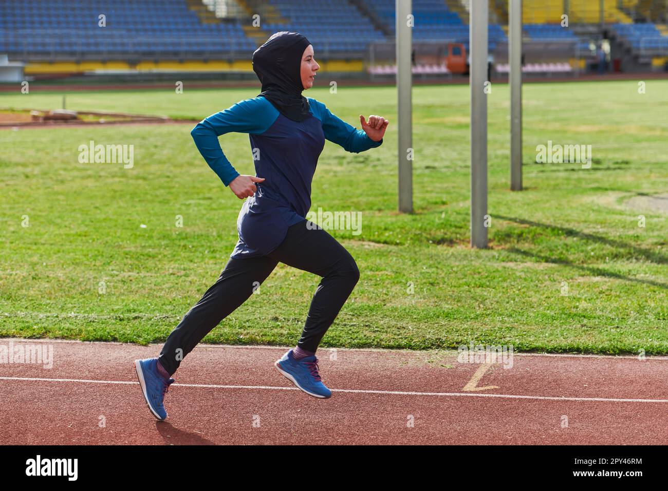 A muslim woman in a burqa sports muslim clothes running on a marathon ...