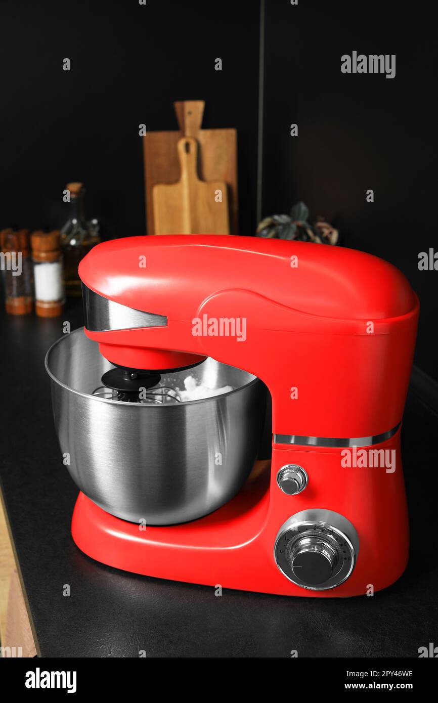 Modern red stand mixer on countertop in kitchen Stock Photo - Alamy