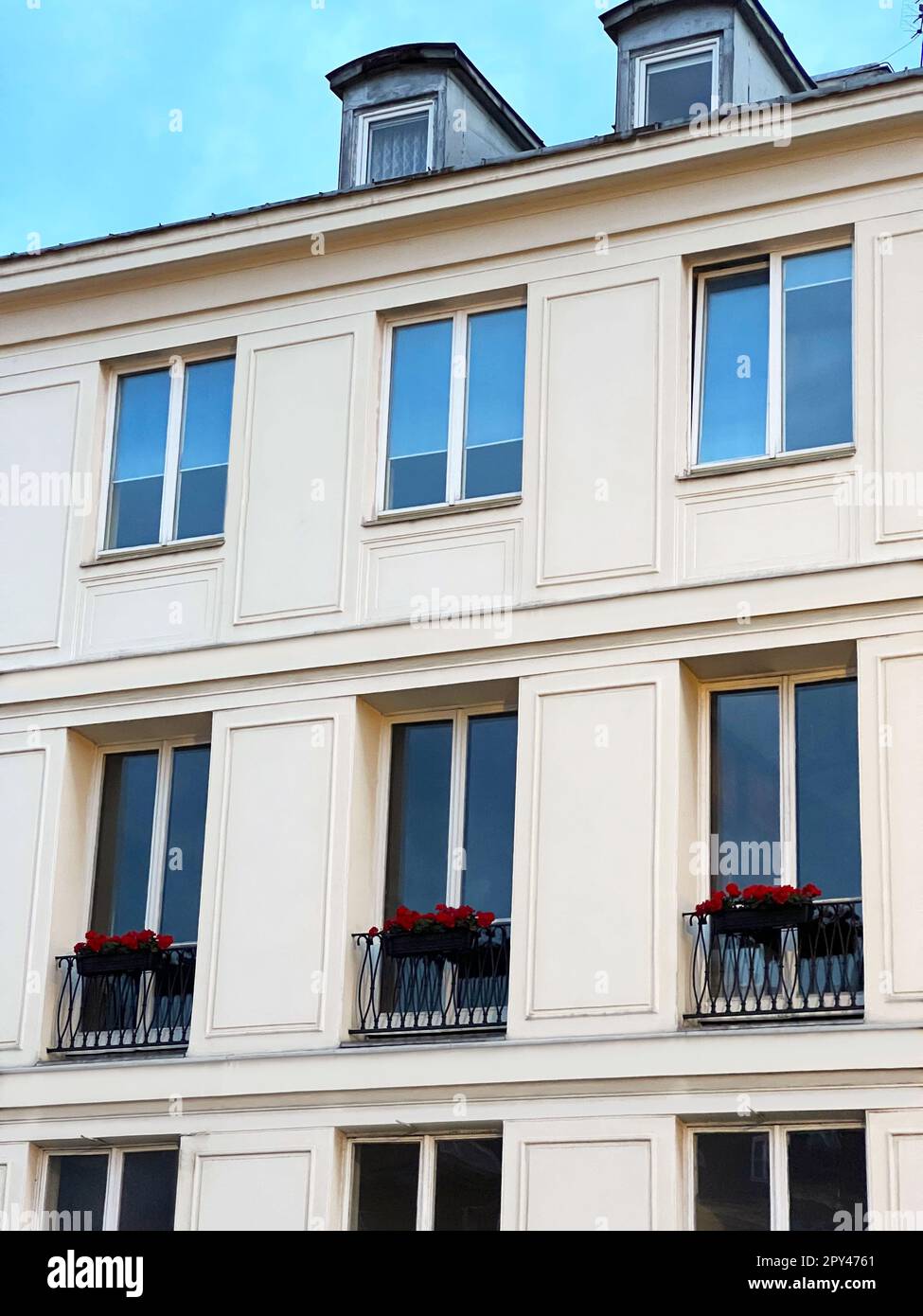 Modern building exterior with flowers on window railings Stock Photo ...
