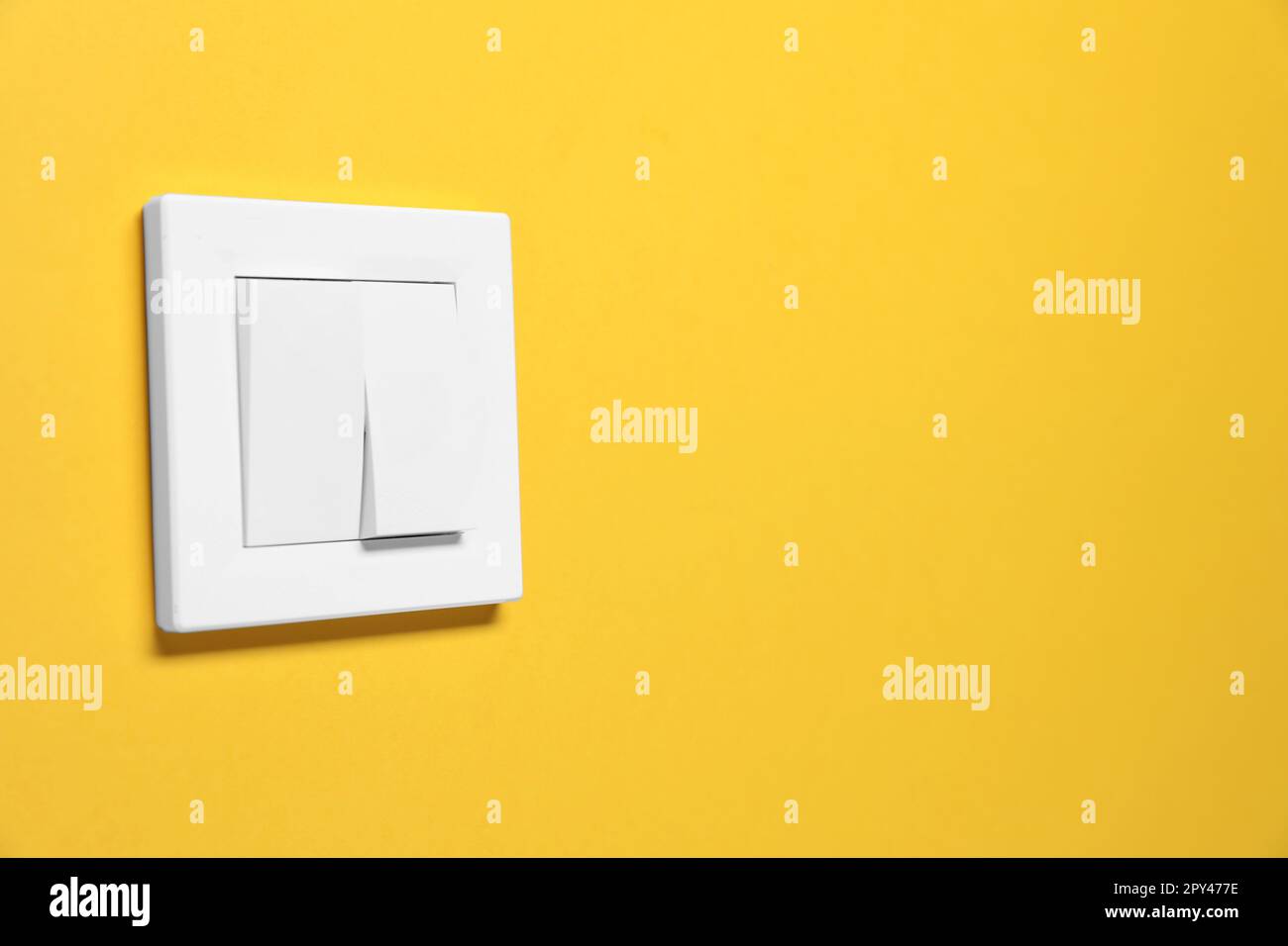 Modern plastic light switch on orange background. Space for text Stock ...