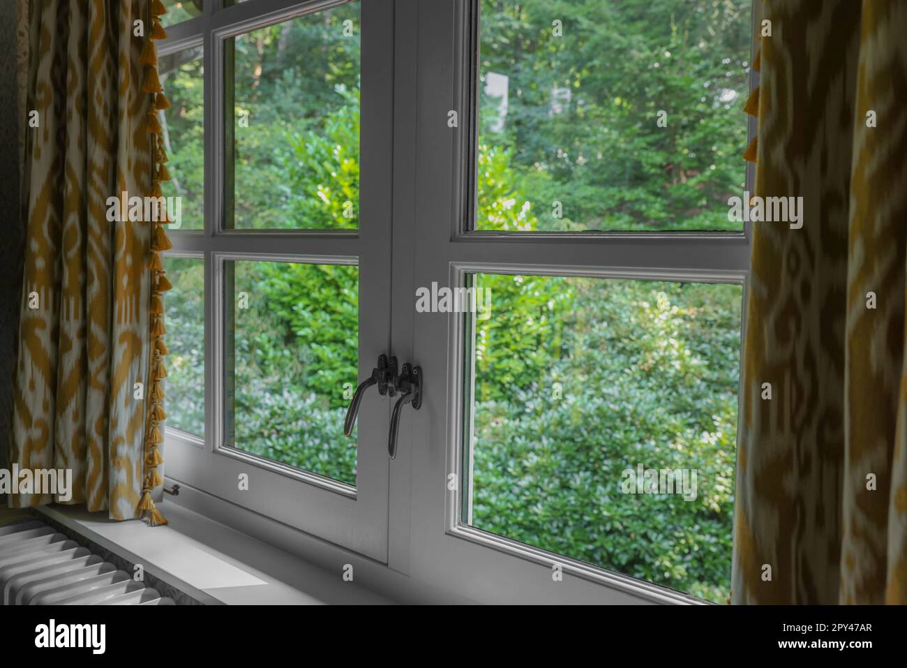 Old fashioned window with beautiful curtains in room. Interior design ...