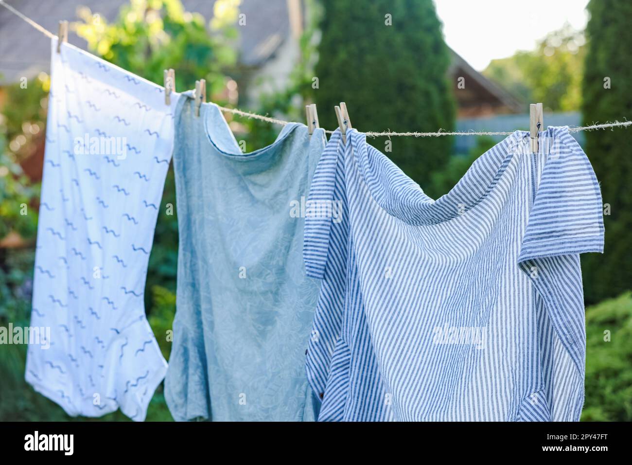 Shirts drying on washing line outdoors. Clean clothes Stock Photo - Alamy