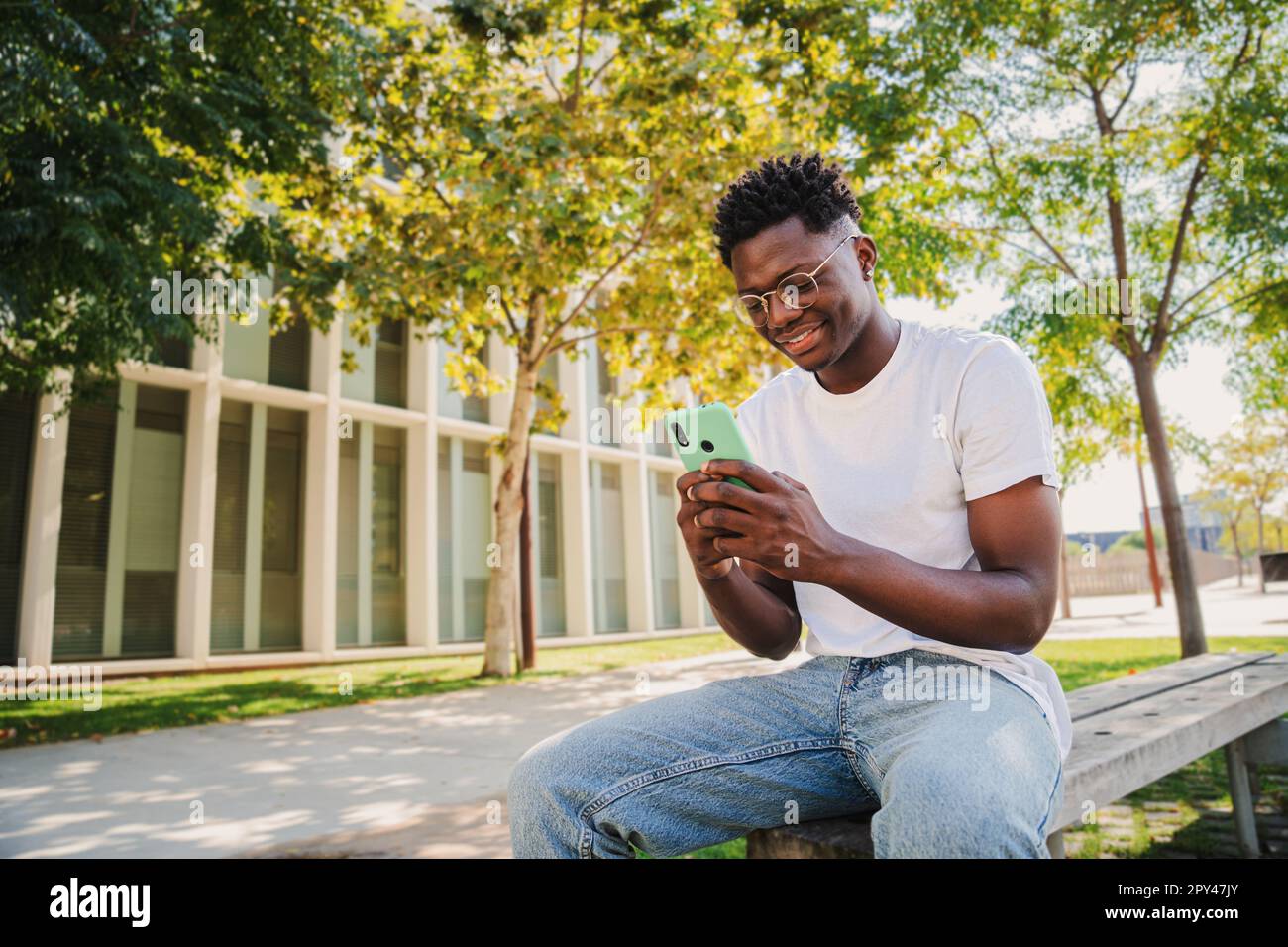 Happy man sending text hi-res stock photography and images - Alamy