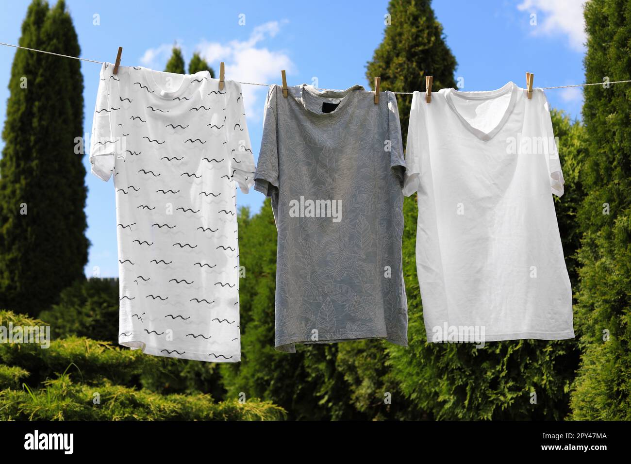 Washing line with clean clothes in garden. Drying laundry outside Stock ...