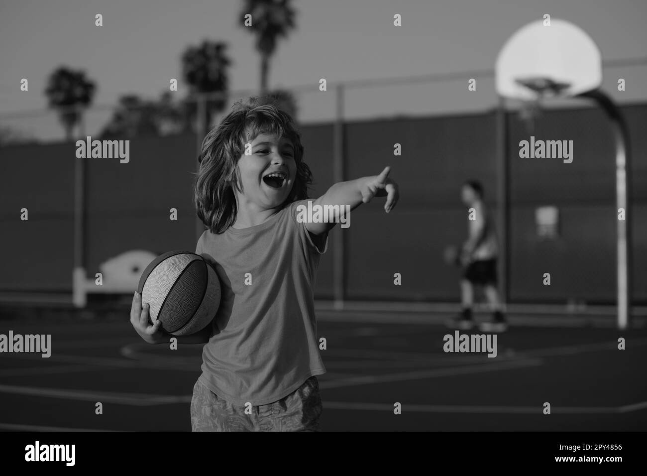 Basketball kids game. Cute little boy laughing and holding a basketball ...