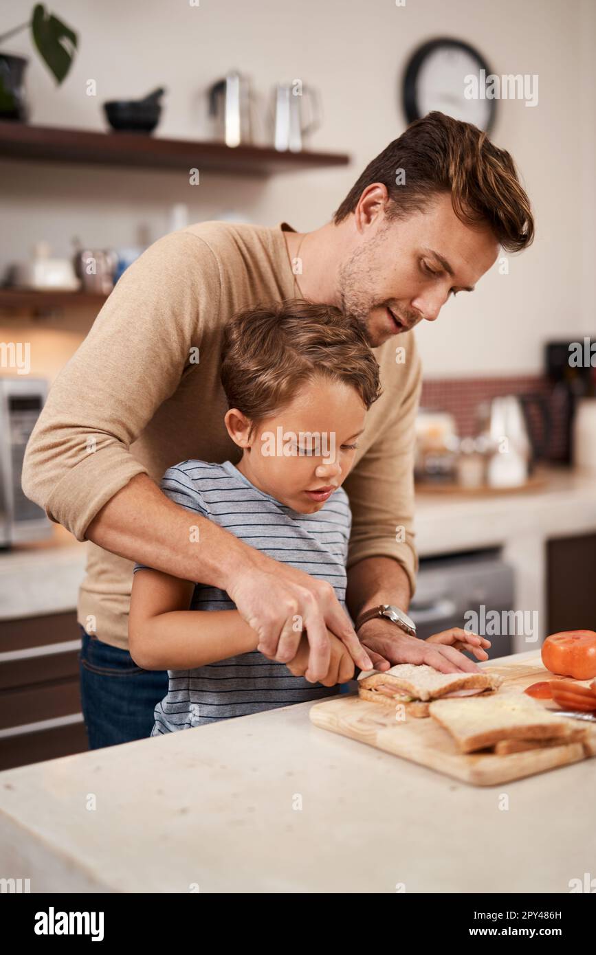This is going to be tasty and filling. a young boy making a sandwich ...