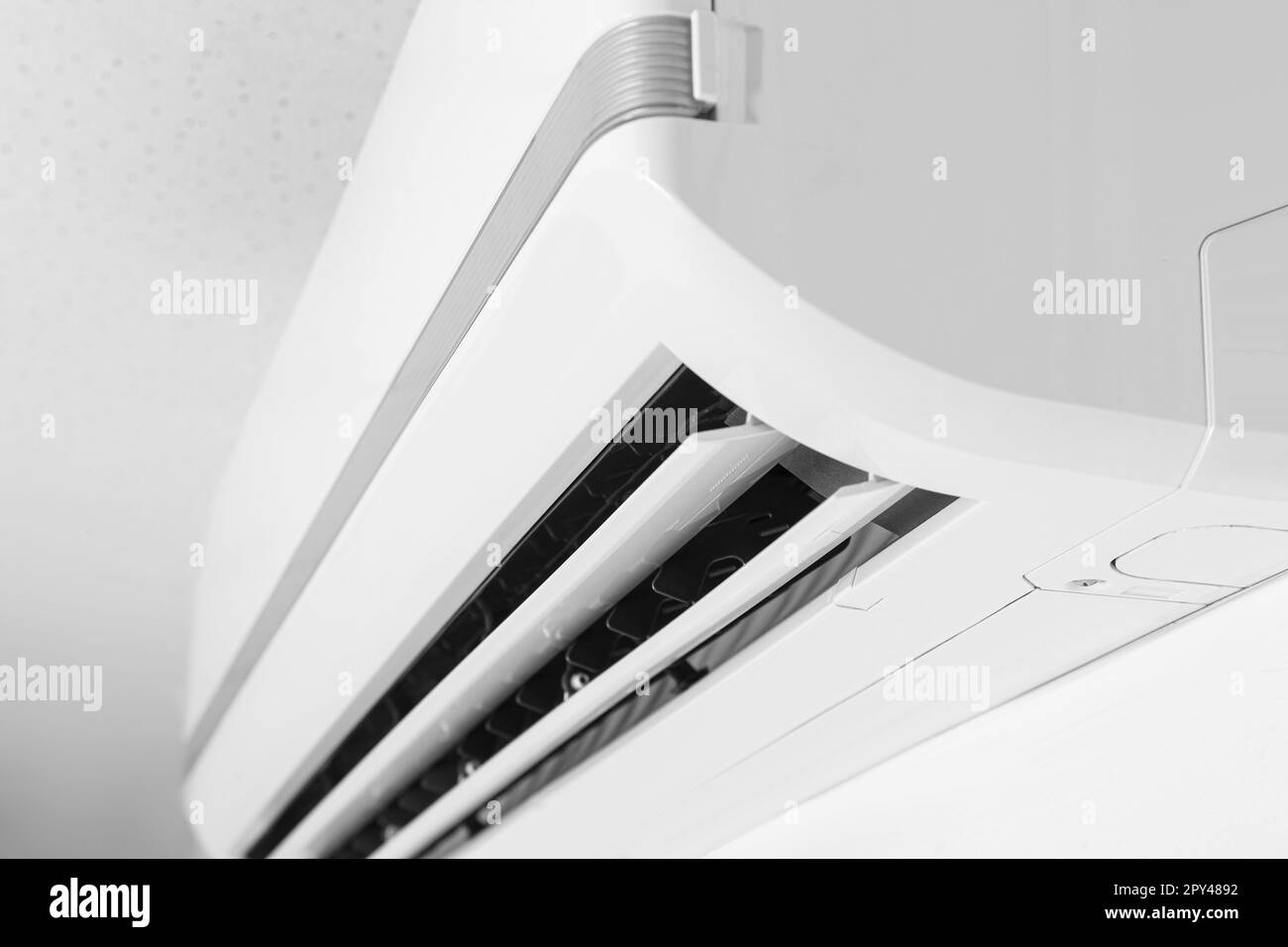 Modern air conditioner on white wall, closeup Stock Photo - Alamy