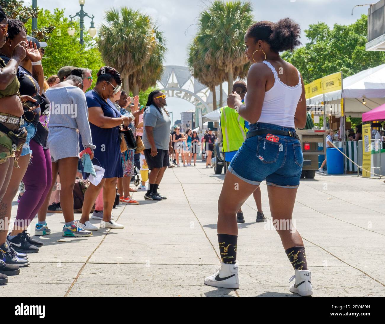 NEW ORLEANS, LA, USA - MARCH 26, 2023: Woman in the foreground dancing ...