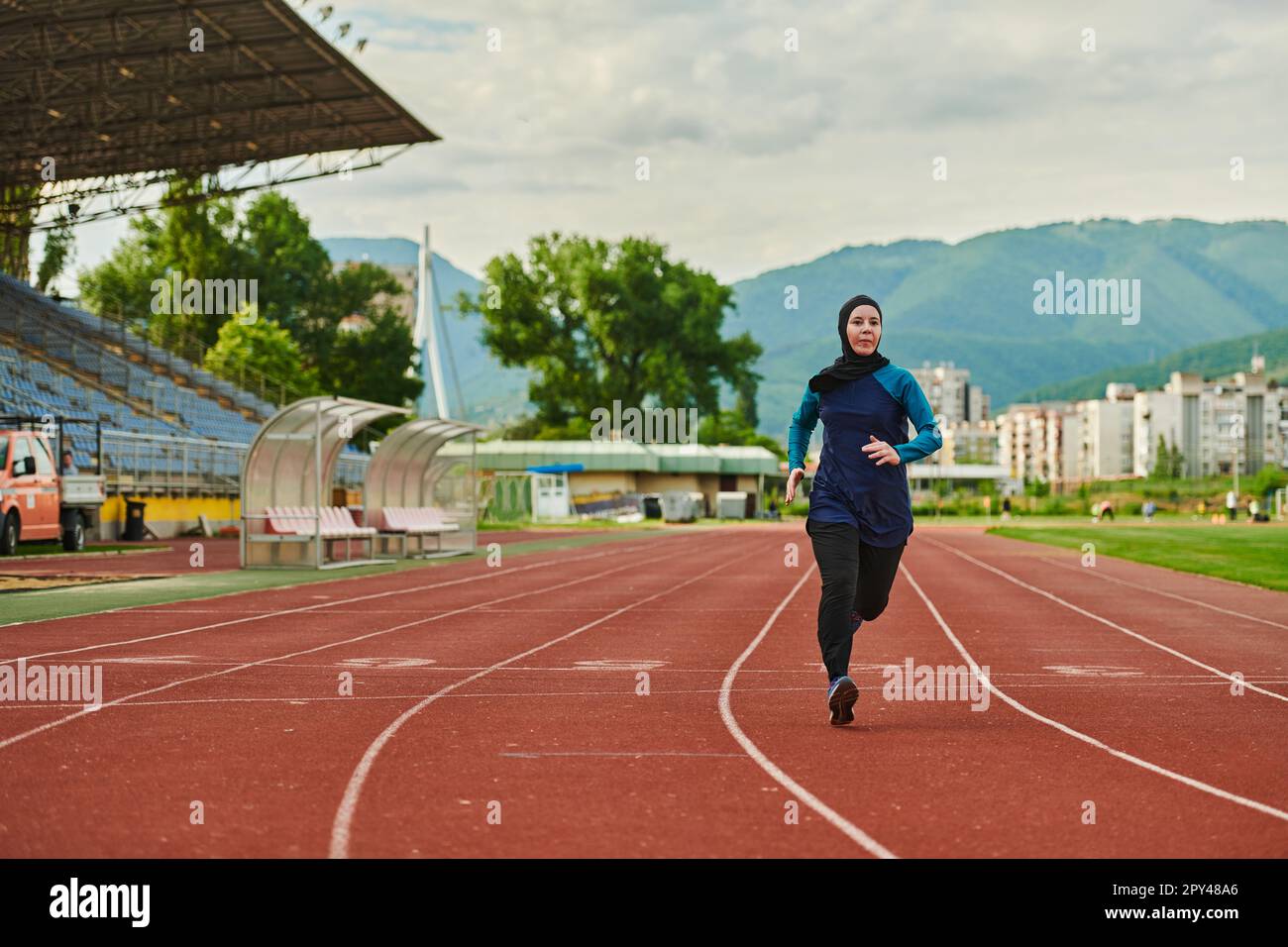 A muslim woman in a burqa sports muslim clothes running on a marathon ...