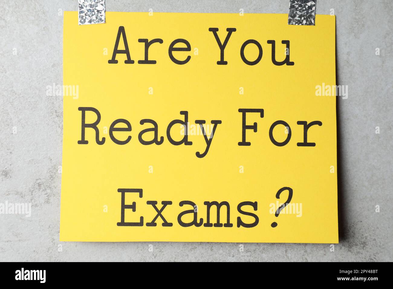 Sheet of paper with question Are You Ready For Exams? on grey table ...