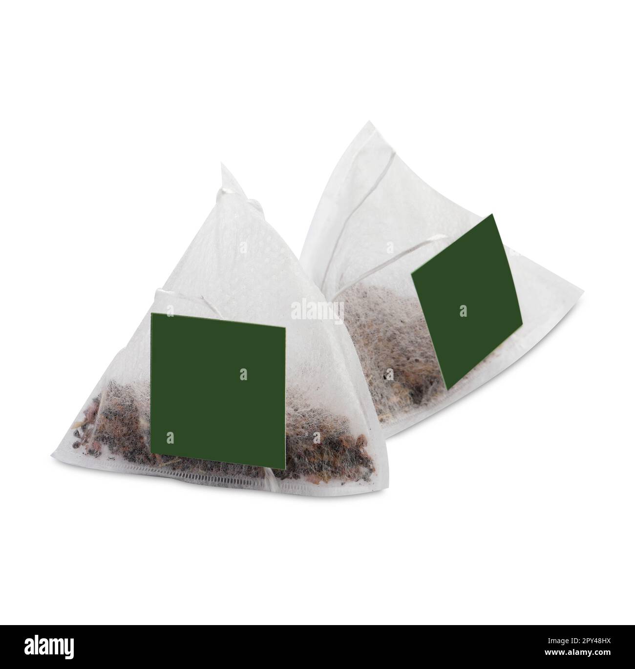 New pyramid tea bags on white background Stock Photo - Alamy