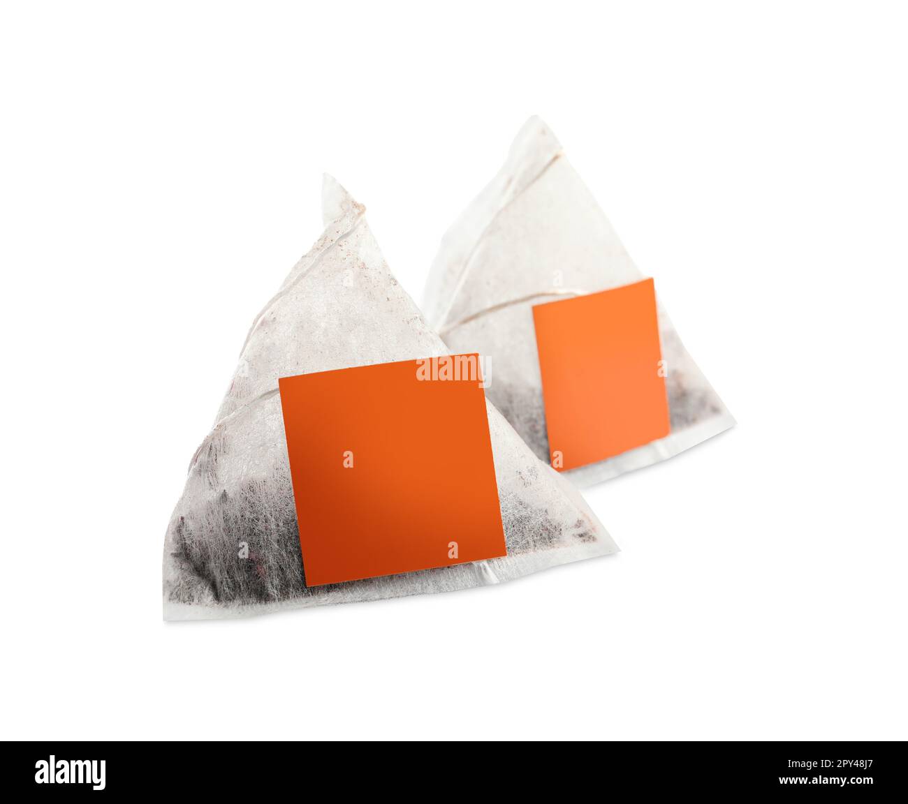 New pyramid tea bags on white background Stock Photo - Alamy