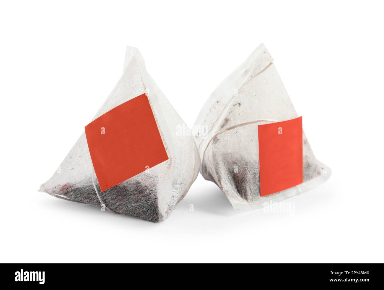 New pyramid tea bags on white background Stock Photo - Alamy
