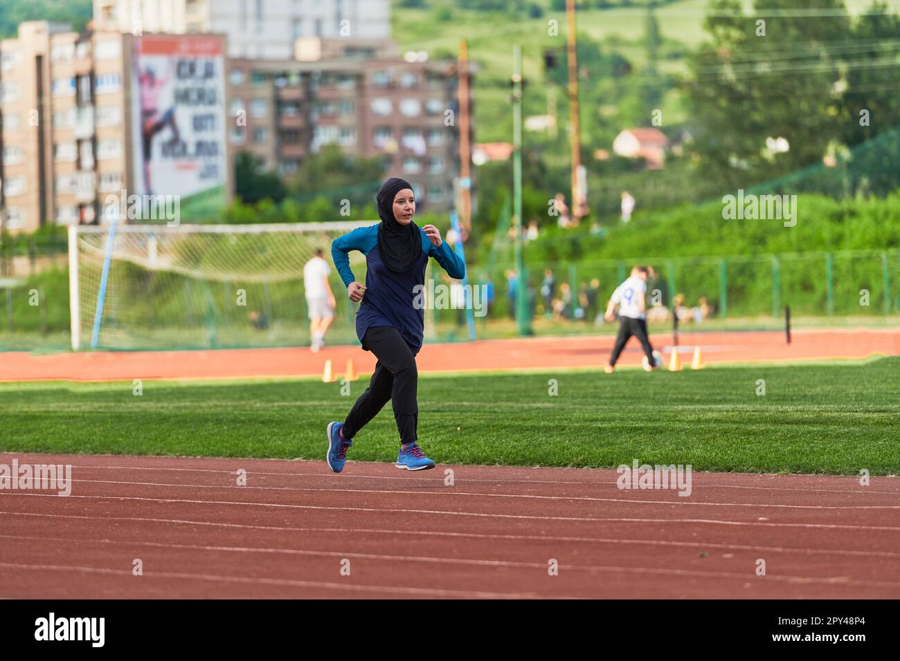 A muslim woman in a burqa sports muslim clothes running on a marathon ...