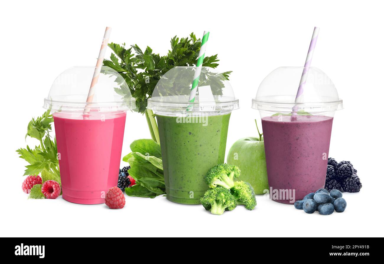 Set with different delicious smoothies in plastic cups on white ...