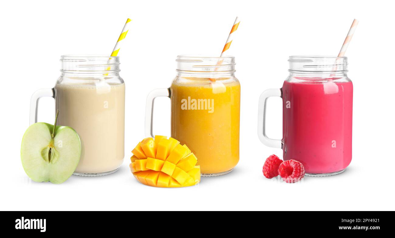 Set with different delicious smoothies in mason jars on white ...