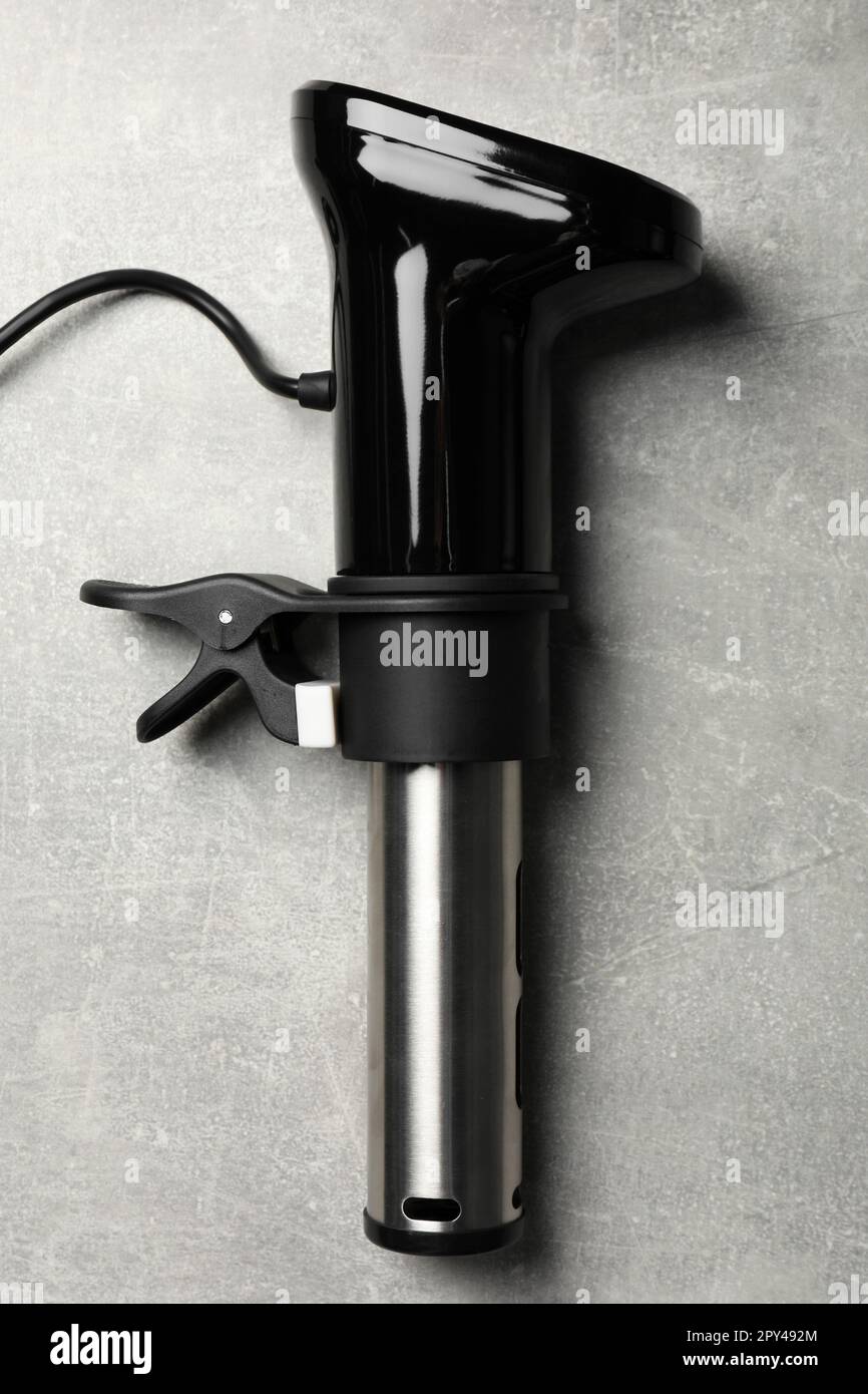 Thermal immersion circulator on light grey table, top view. Sous vide ...