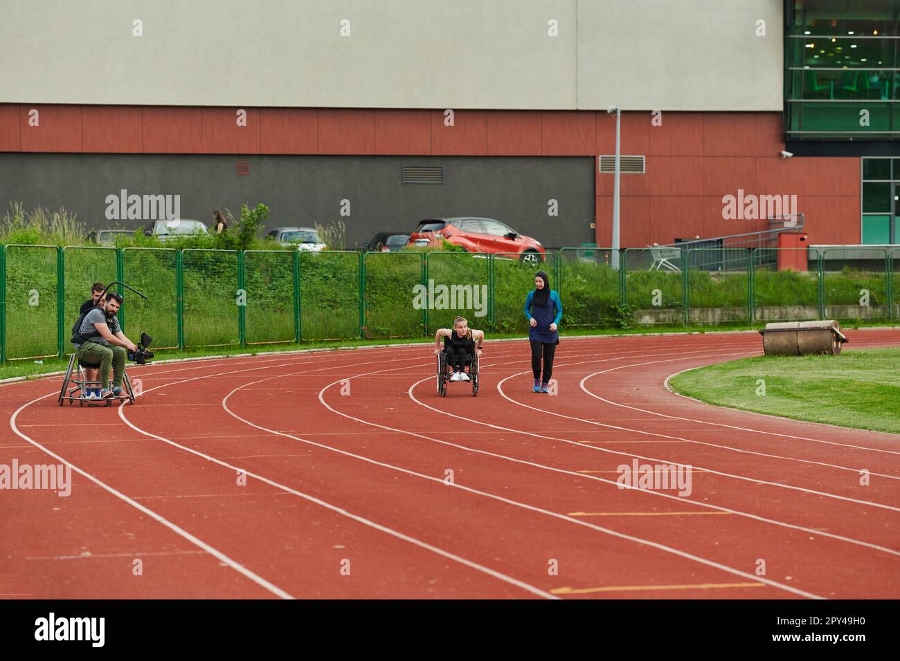 A cameraman filming the participants of the Paralympic race on the ...