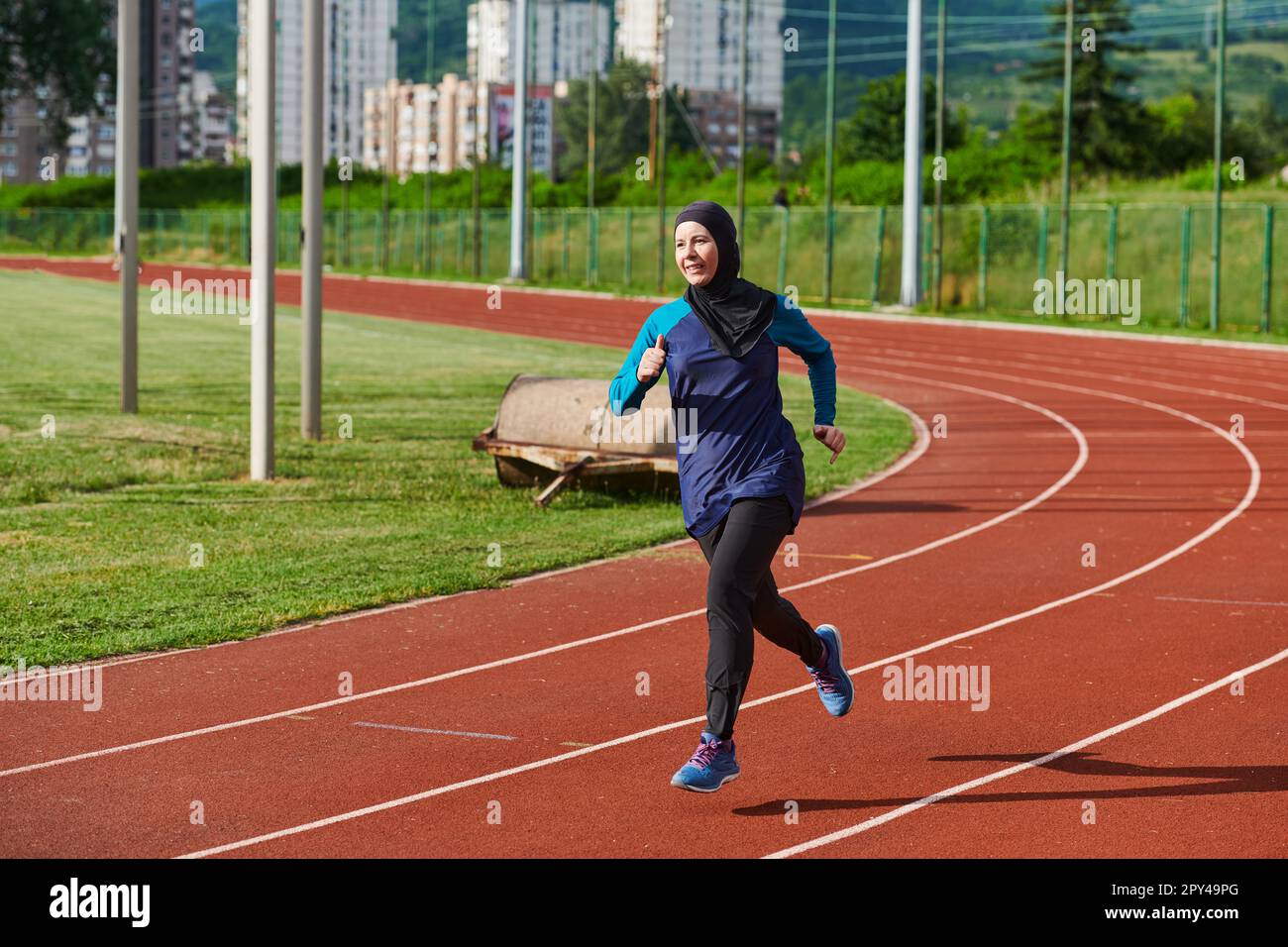 A muslim woman in a burqa sports muslim clothes running on a marathon ...