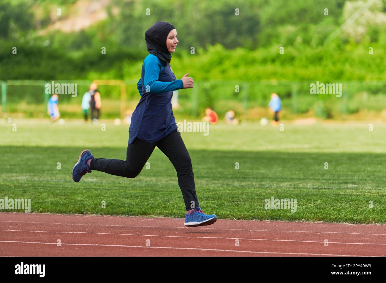 A muslim woman in a burqa sports muslim clothes running on a marathon ...
