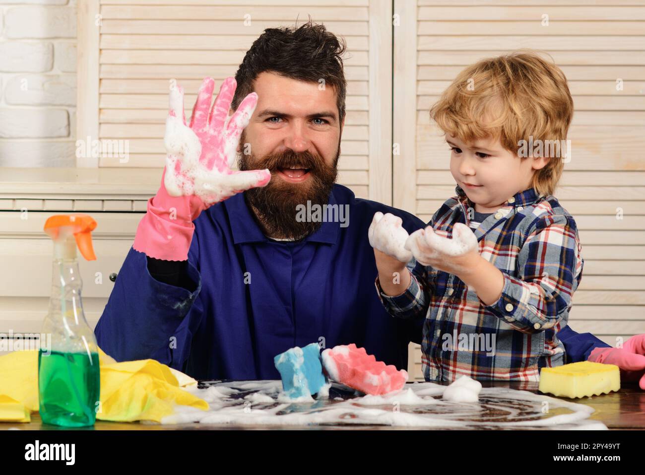 Dad and son with cleaning supplies. Father and child boy ready to do ...