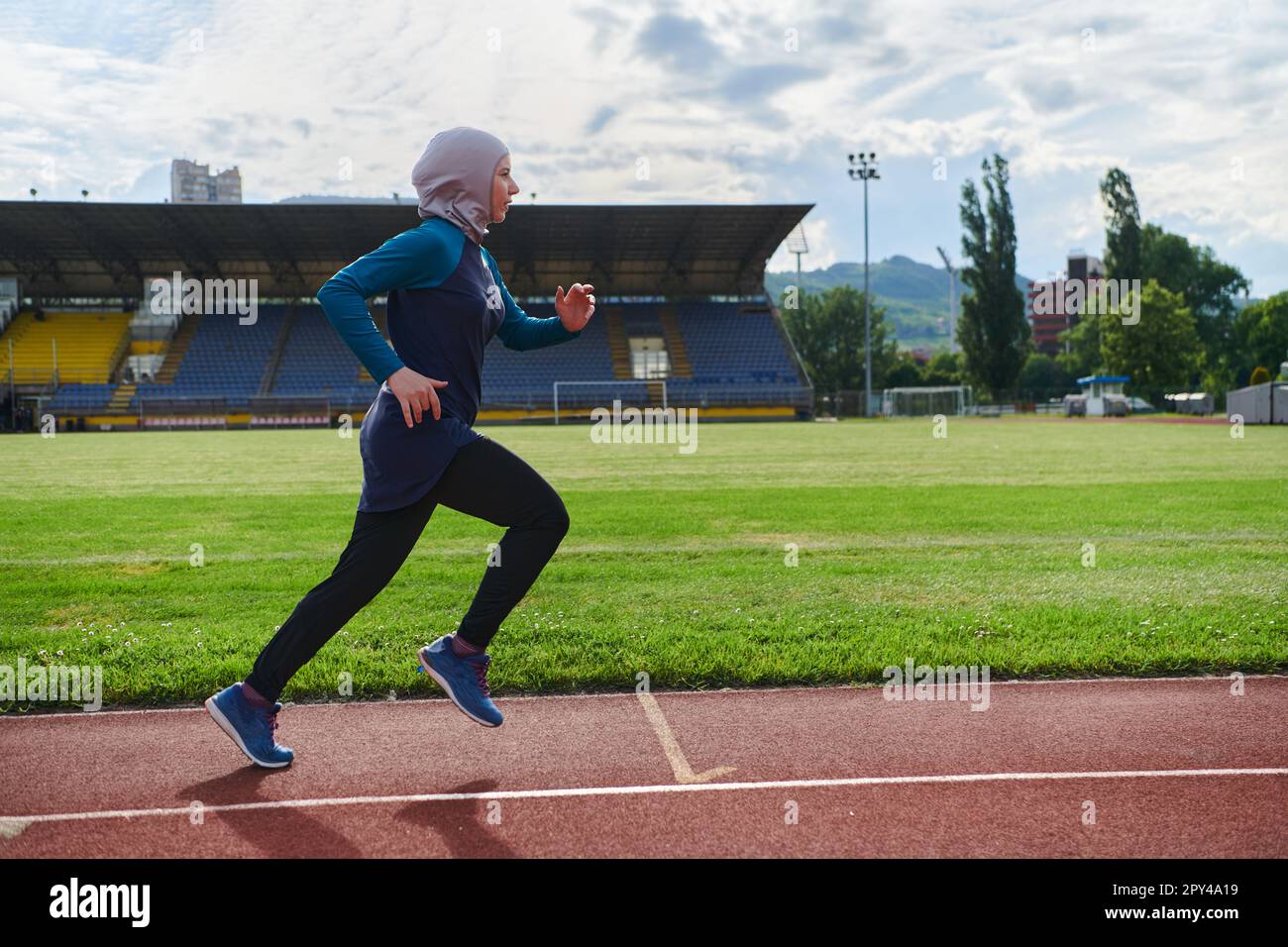 A muslim woman in a burqa sports muslim clothes running on a marathon ...