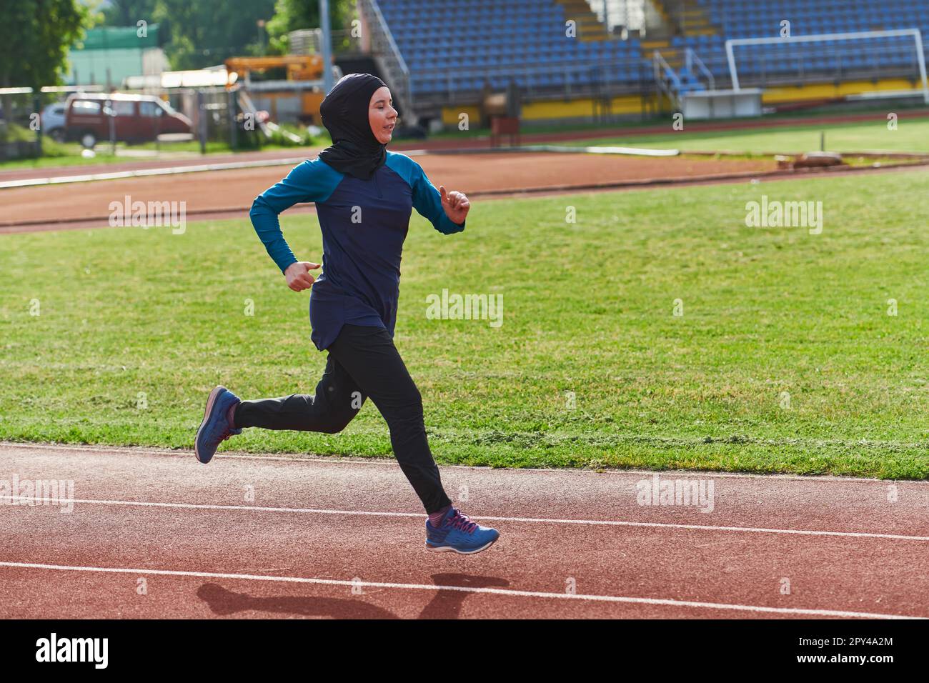 A muslim woman in a burqa sports muslim clothes running on a marathon ...