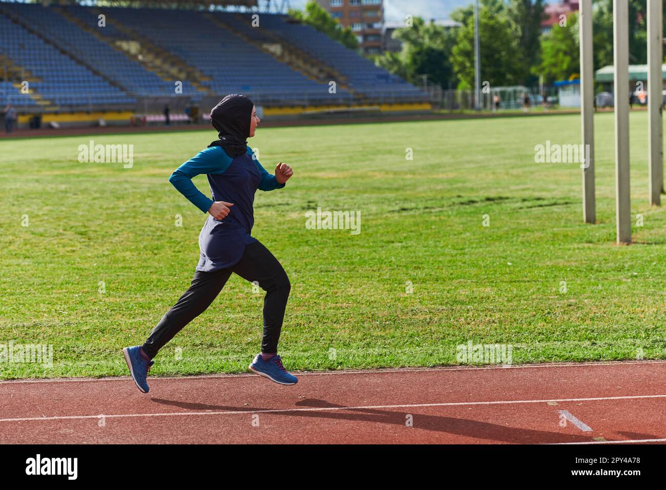 A muslim woman in a burqa sports muslim clothes running on a marathon ...