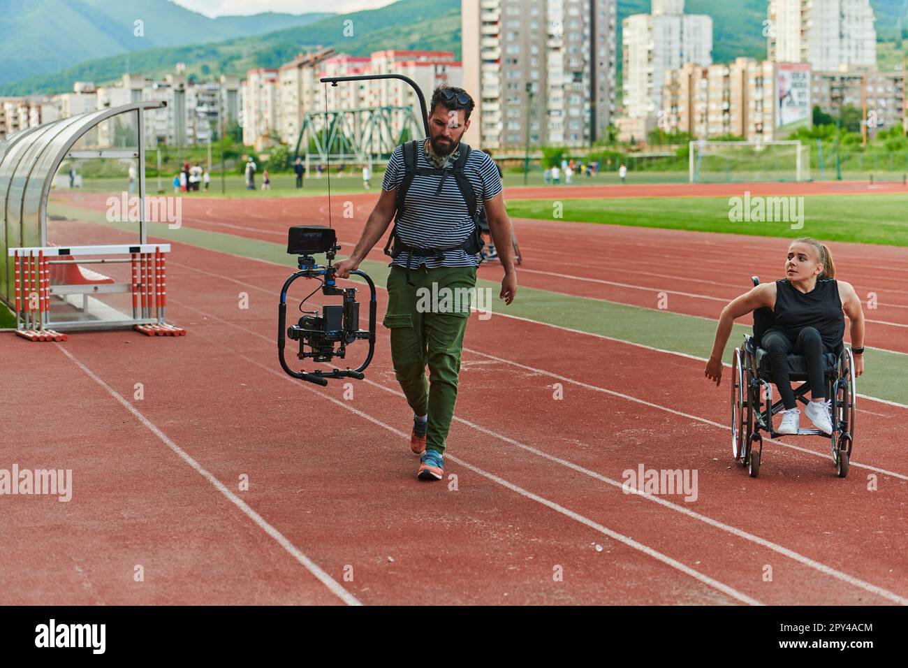 A cameraman filming the participants of the Paralympic race on the ...