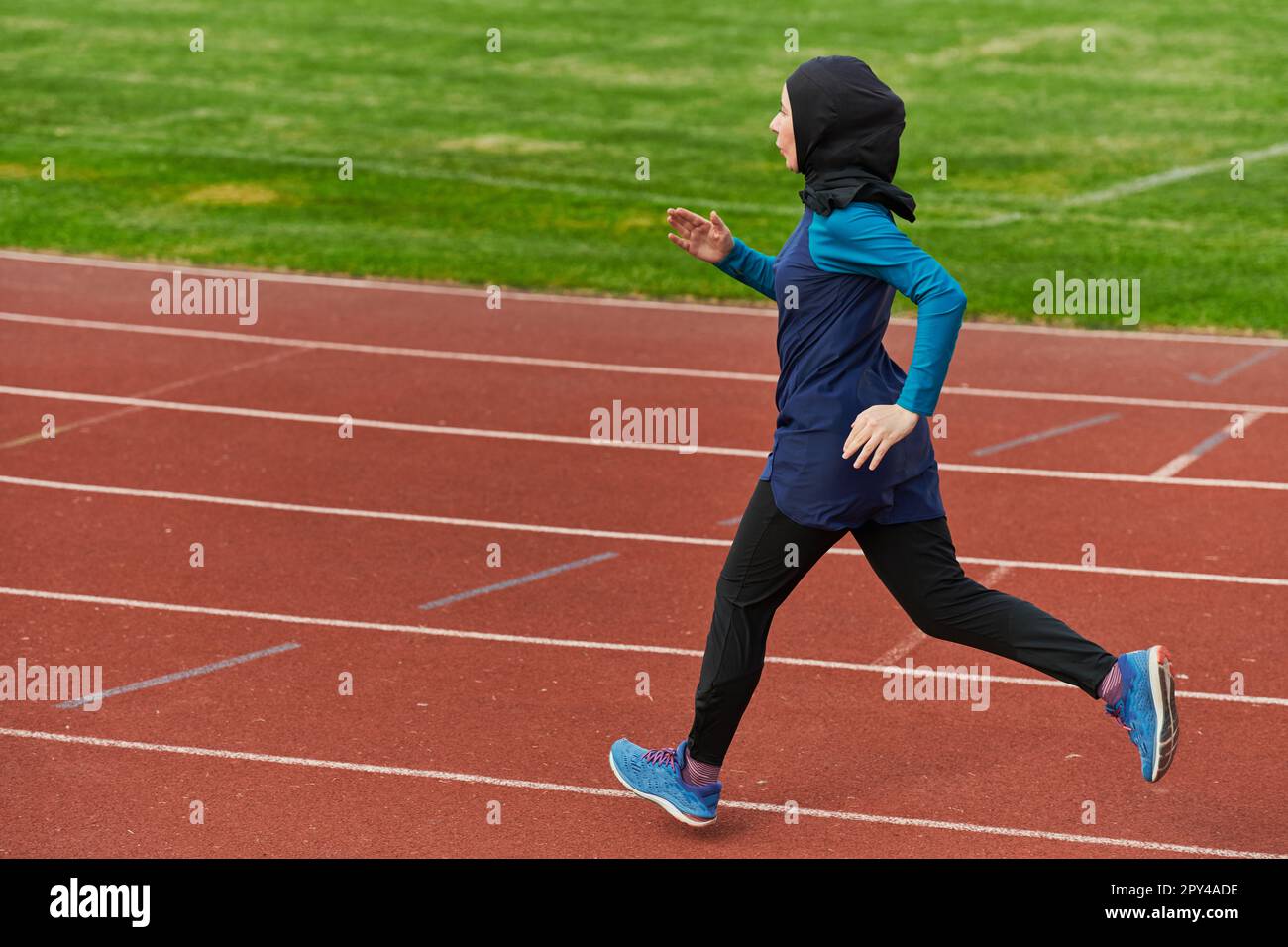 A muslim woman in a burqa sports muslim clothes running on a marathon ...