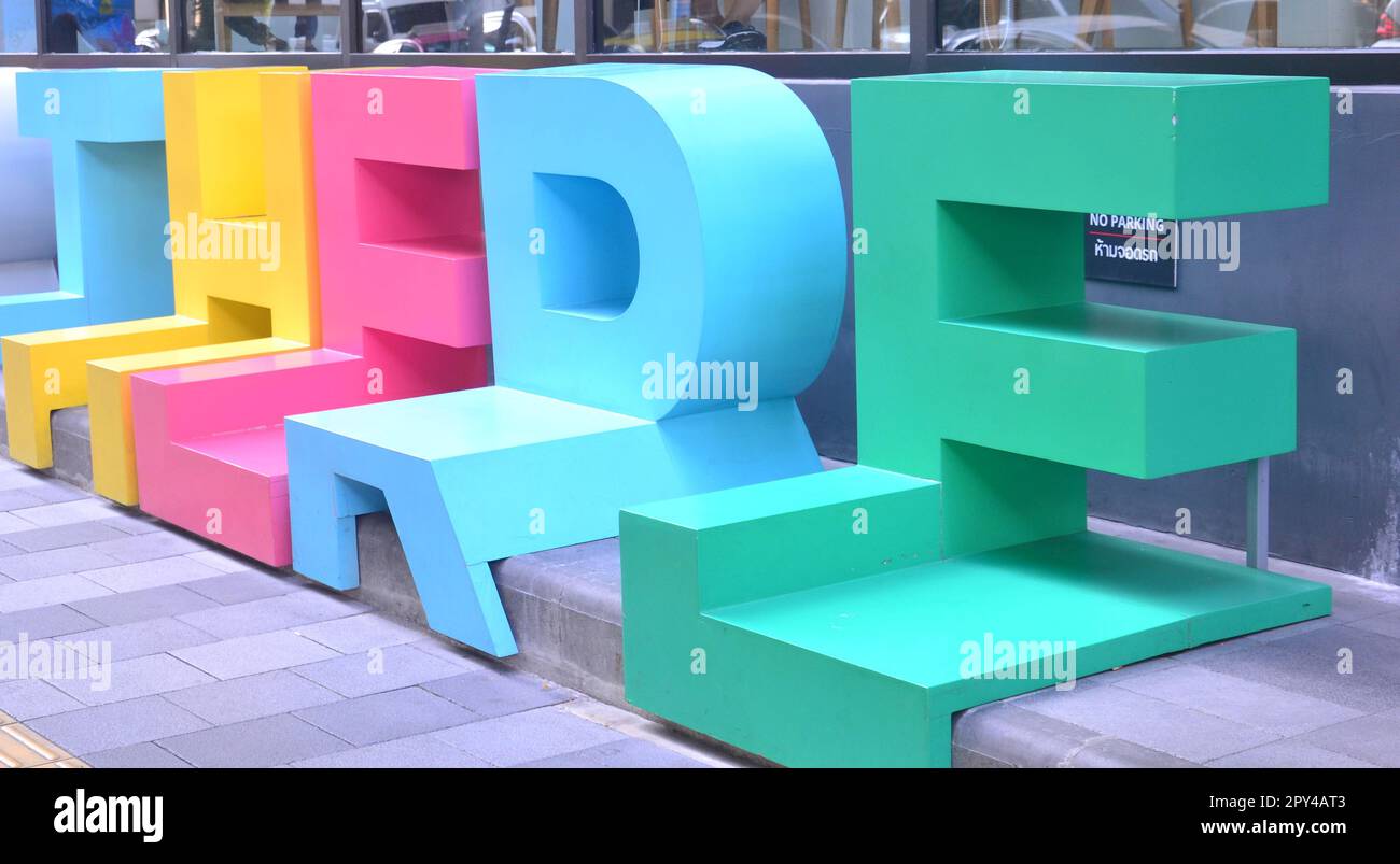 Sign, signage, notice, unusual 3d sign says: 'here' Stock Photo - Alamy