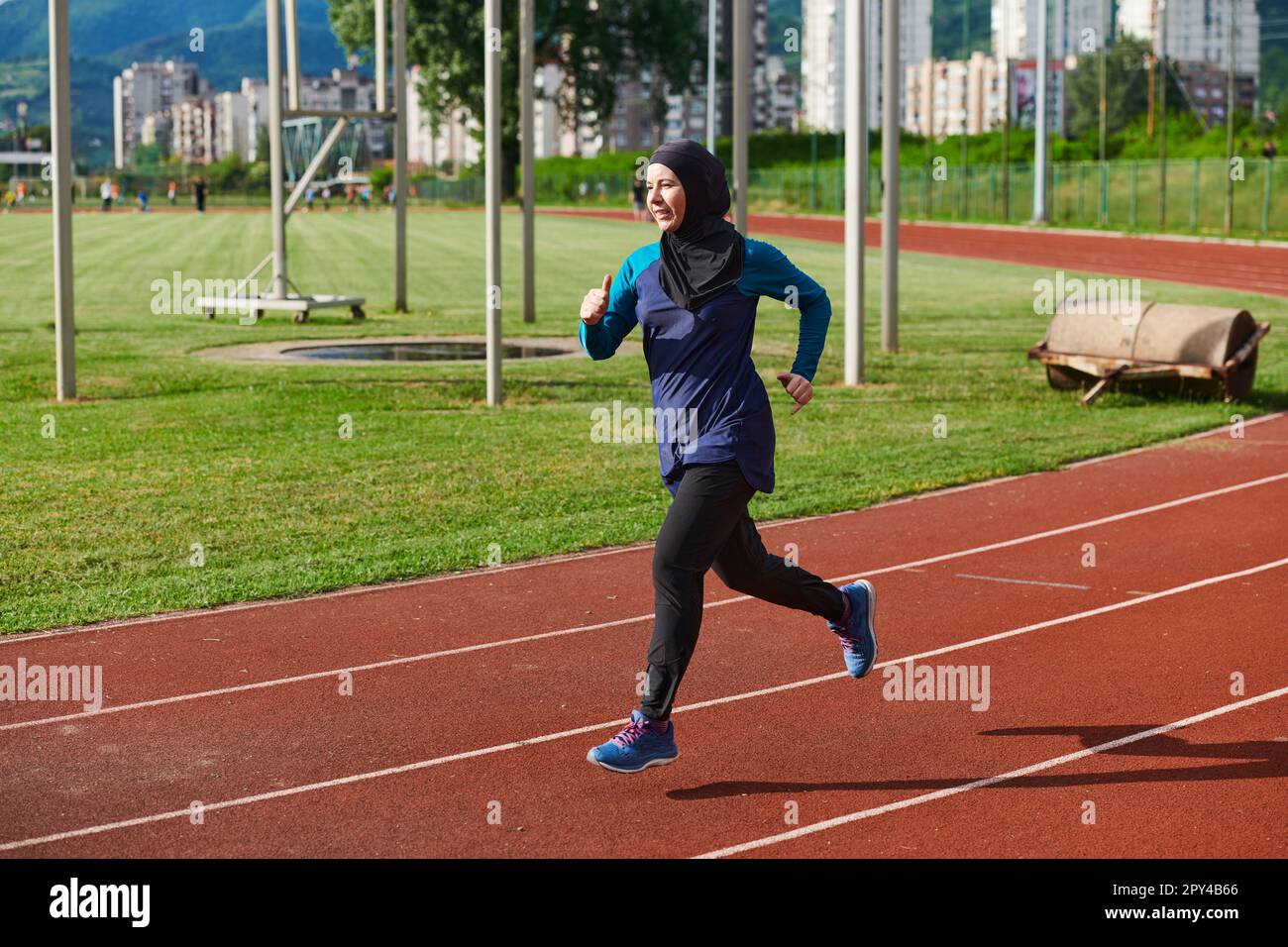 A muslim woman in a burqa sports muslim clothes running on a marathon ...