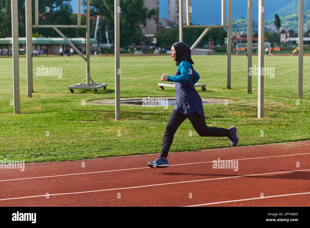 A muslim woman in a burqa sports muslim clothes running on a marathon ...