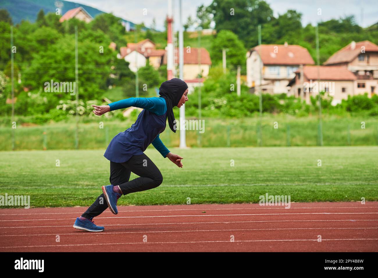 A muslim woman in a burqa sports muslim clothes running on a marathon ...