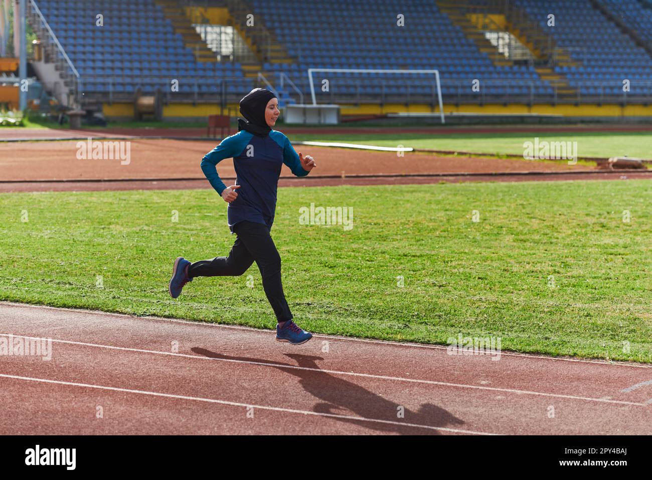 A muslim woman in a burqa sports muslim clothes running on a marathon ...