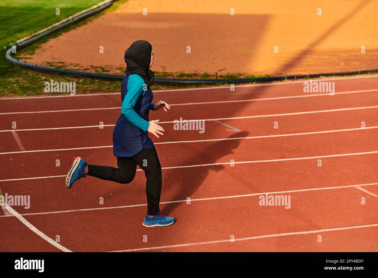 A muslim woman in a burqa sports muslim clothes running on a marathon ...
