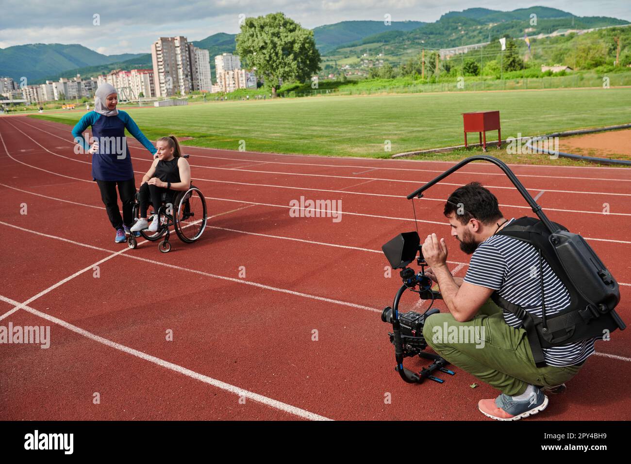 A cameraman filming the participants of the Paralympic race on the ...