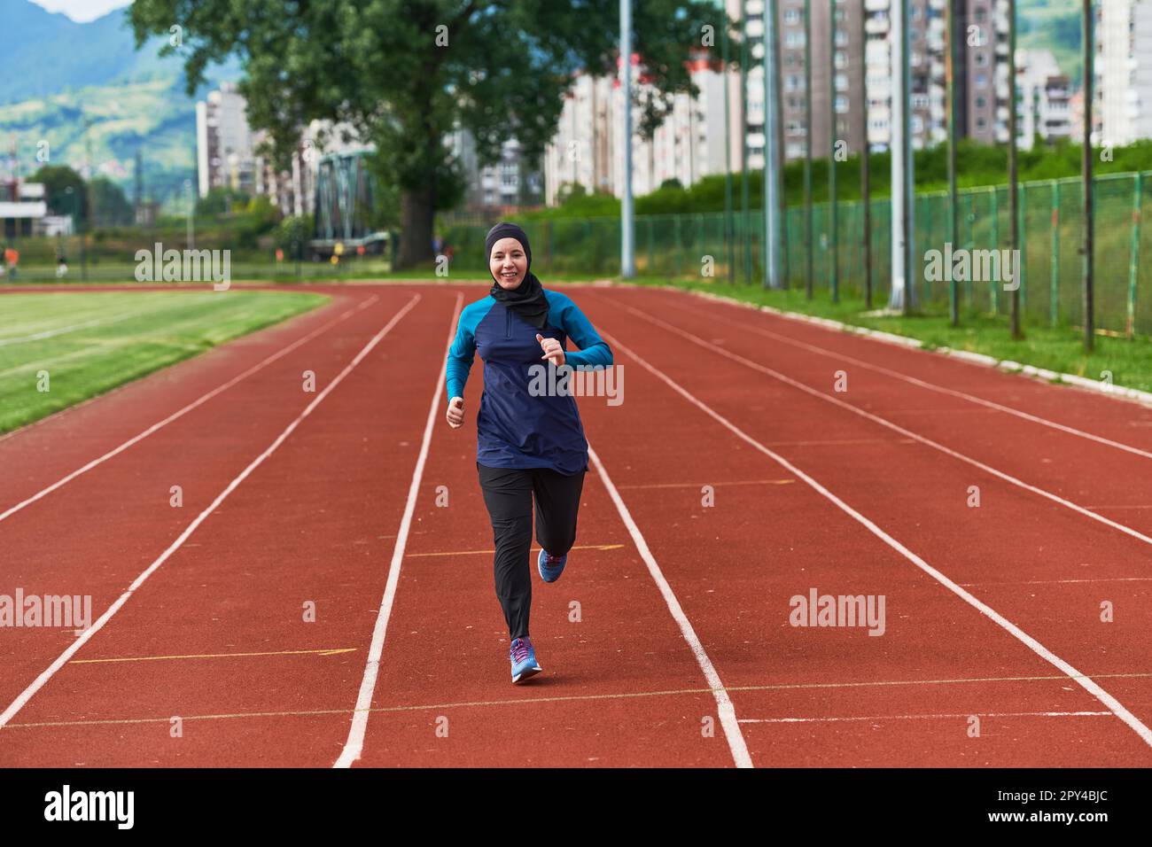 A muslim woman in a burqa sports muslim clothes running on a marathon ...