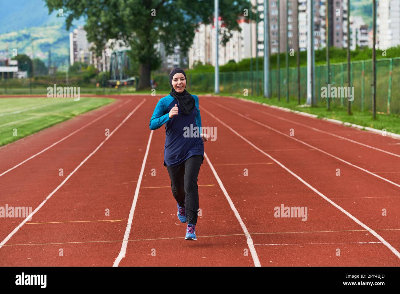 A muslim woman in a burqa sports muslim clothes running on a marathon ...