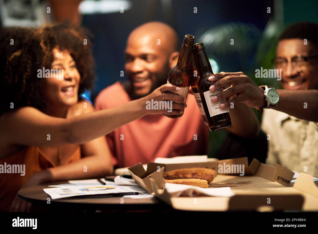 Cheers to great success. a group of businesspeople having beers at the ...