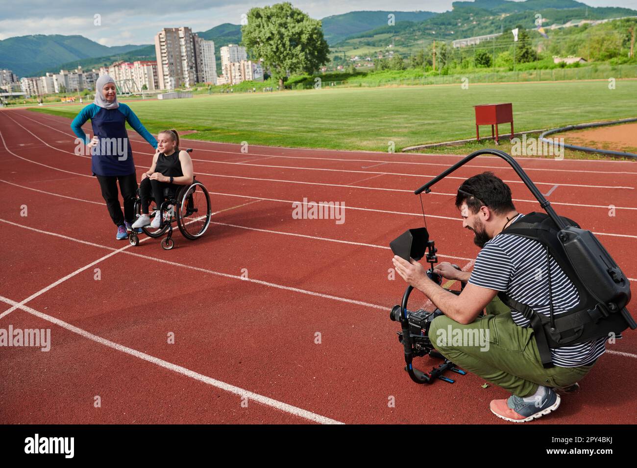 A cameraman filming the participants of the Paralympic race on the ...