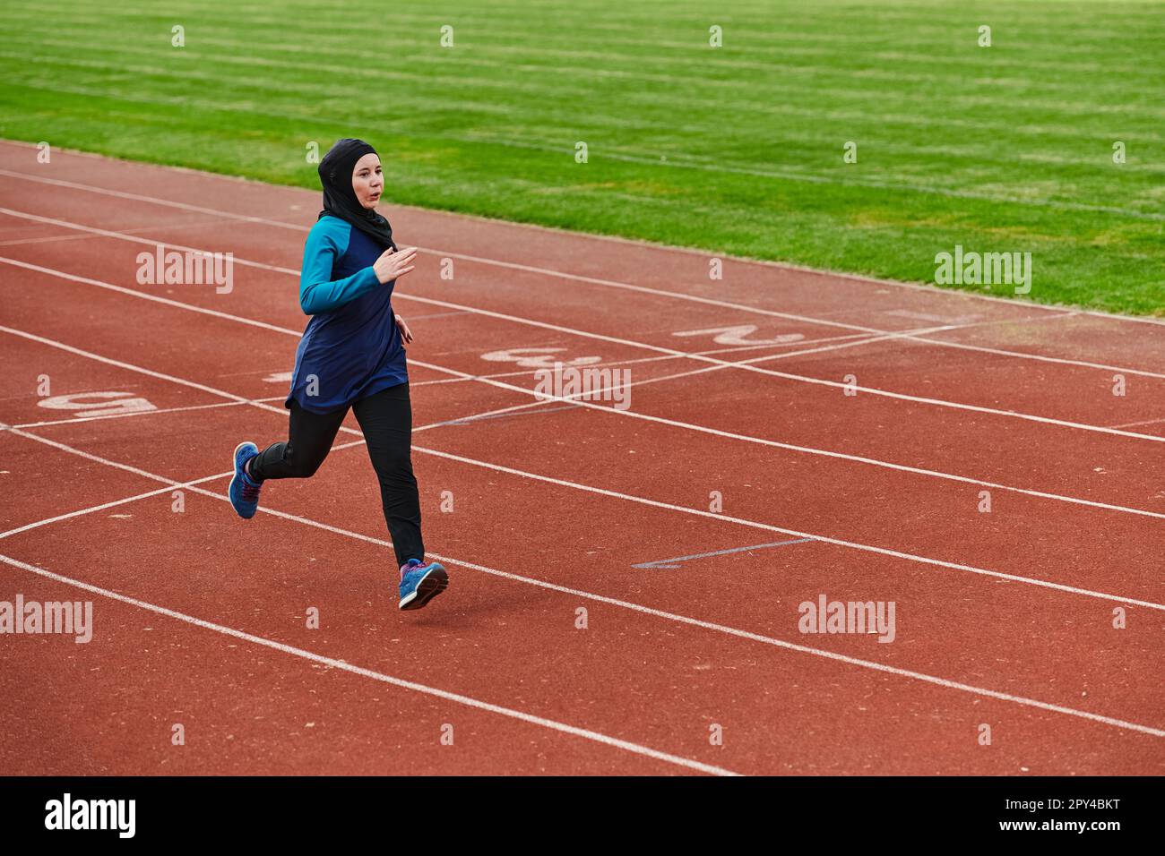 A muslim woman in a burqa sports muslim clothes running on a marathon ...