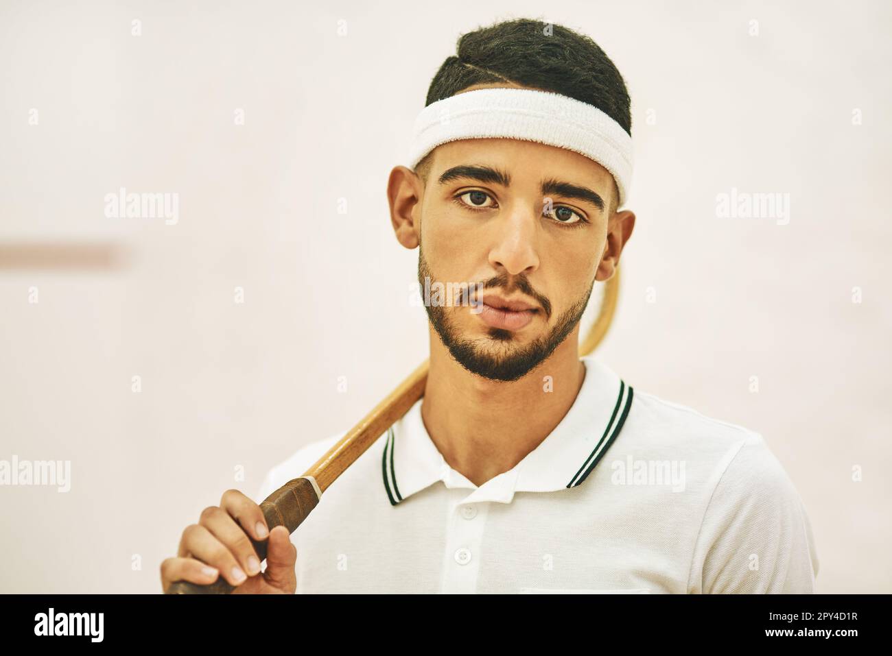 The coolest cat at the squash court. a confident young man standing on ...