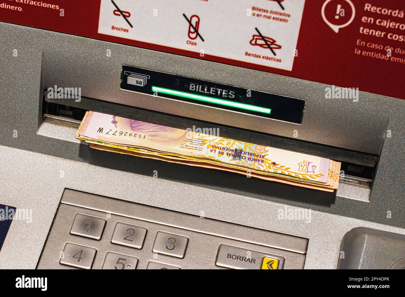 ATM. Automated teller machine. Cash machine. Argentine pesos. Cash withdrawal. Money in ...