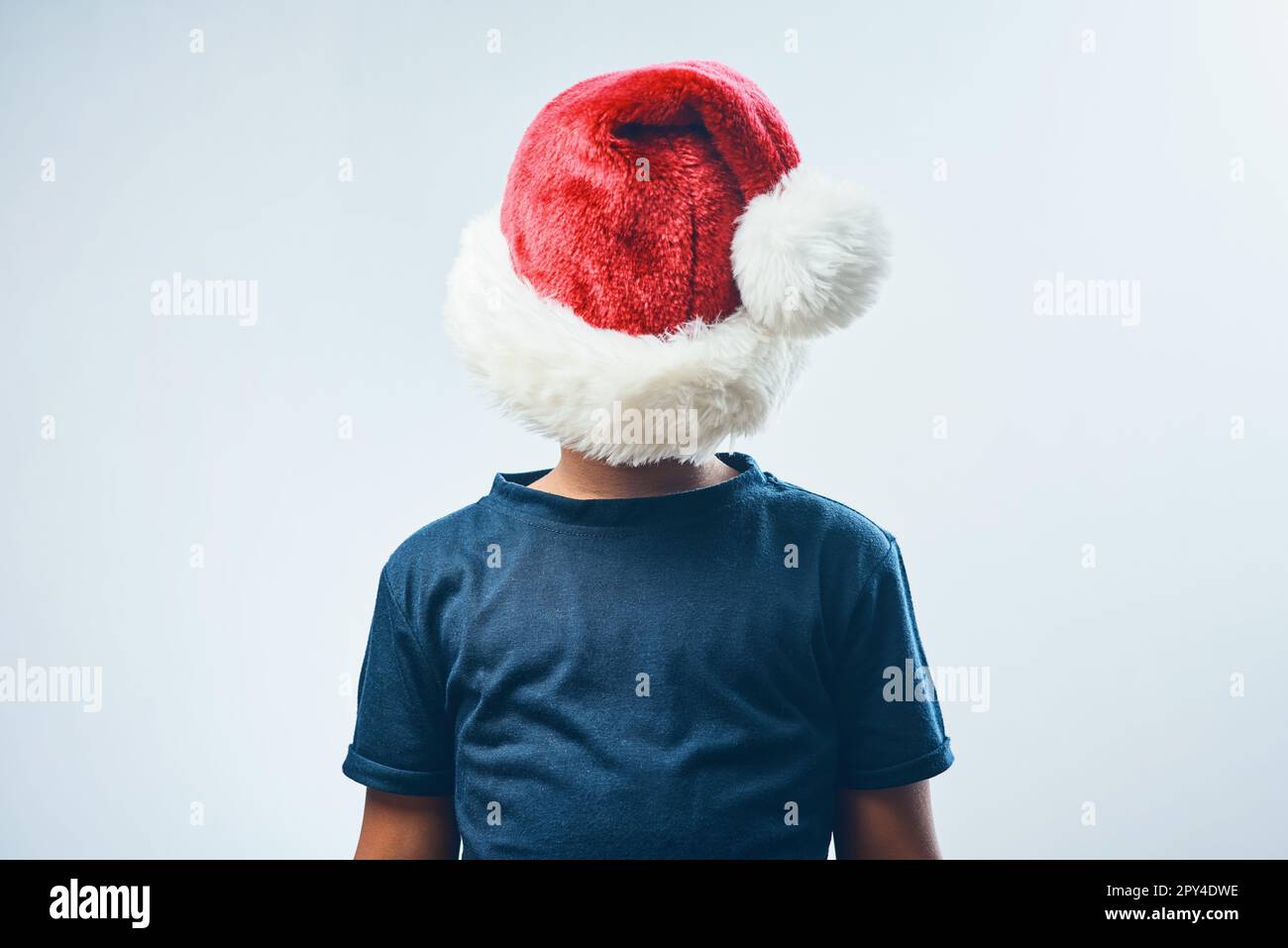 Has anyone seen my hat. Studio shot of a cute little boy covering his ...
